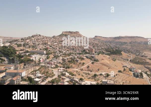 Aerial panning view Mardin old city in southeastern Turkey with citadel ...