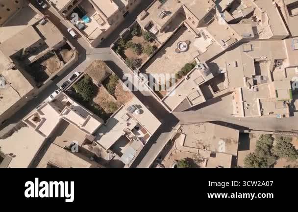 Drone aerial top-down of old stone houses and narrow alleys in Midyat ...