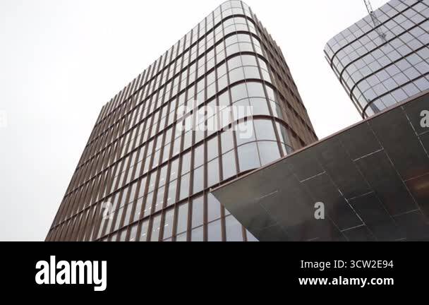 Building features square towers with rounded edges and glass facade ...