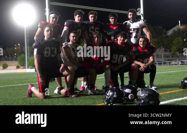Group of determined american football players posing for a team photo ...