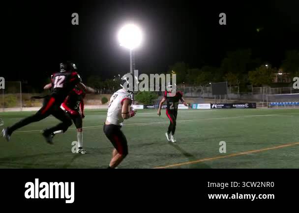 Determined athlete running with the ball to score a touchdown during a ...