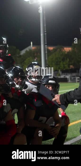 Experienced coach giving an inspirational speech to his kneeling ...