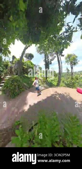 Vertical video. Woman Standing on a Wooden Terrace Seen Through a ...