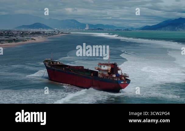 Aerial view, top view of old rusty stranded logistics ship on the beach ...