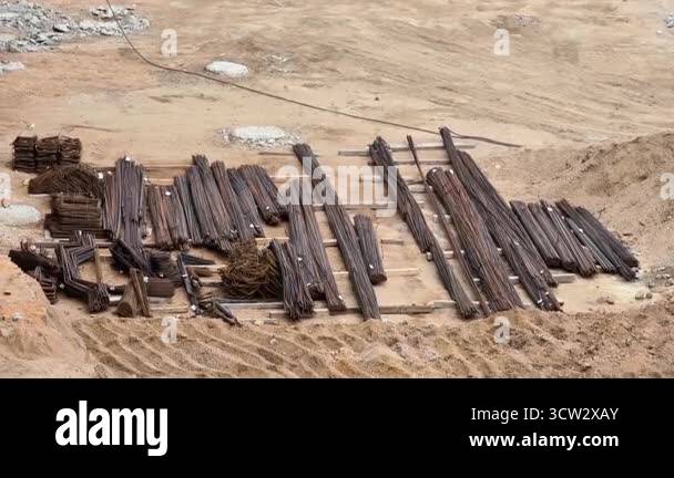 A stockpile of construction materials, including wooden beams and steel ...