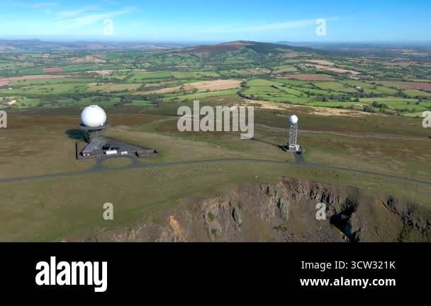 An aerial orbit shot of the Radars on the summit of Titterstone Clee ...