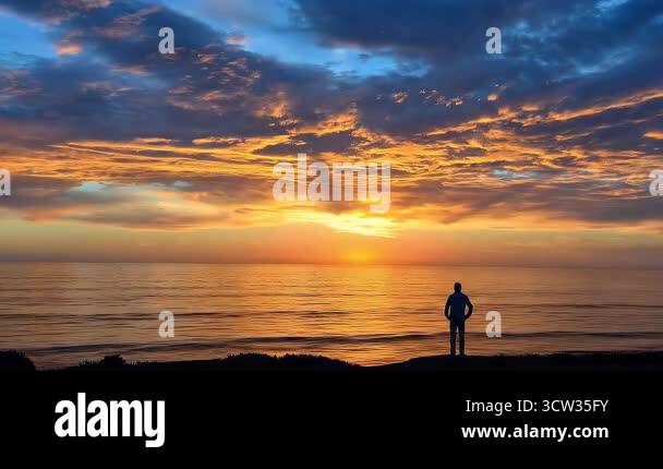Silhouette Of Person Standing On Beach Facing Sunset Stock Video ...