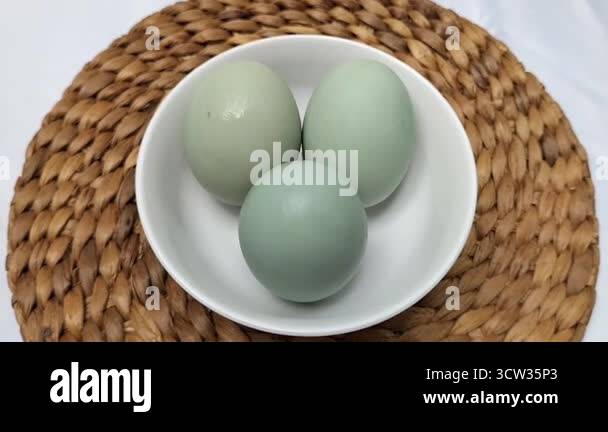Selective focus. Salted blue duck eggs are placed on a white bowl. Salted duck egg processed ...