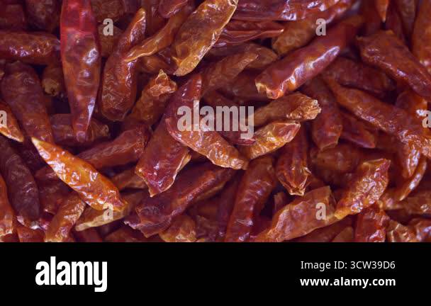 Multiple shots of dried red chili peppers create a vibrant culinary ...