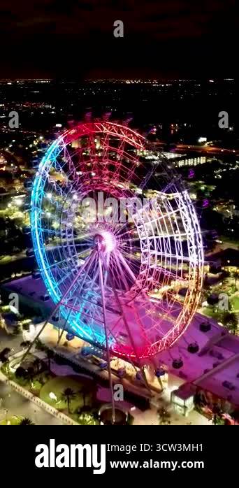 Night landscape of colorful ferris wheel attraction at amusement park ...