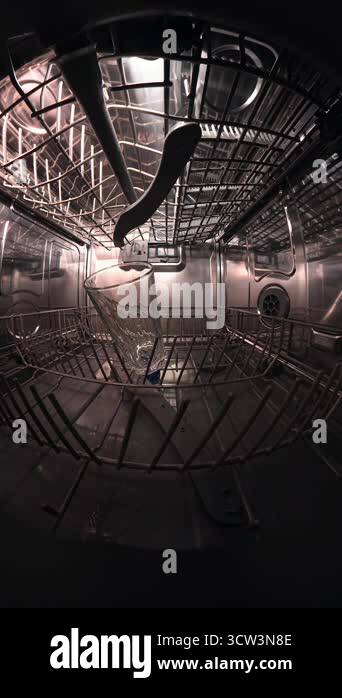 Vertical video. Single Clean Glass Inside Empty Dishwasher After All ...