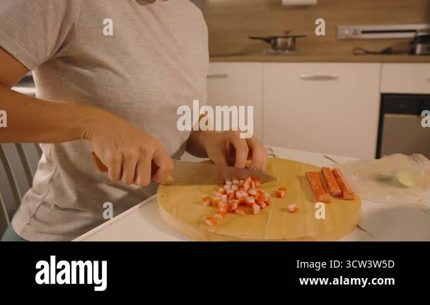 Woman Dicing Crab Sticks into Small Cubes on Wooden Board, Side Angle ...