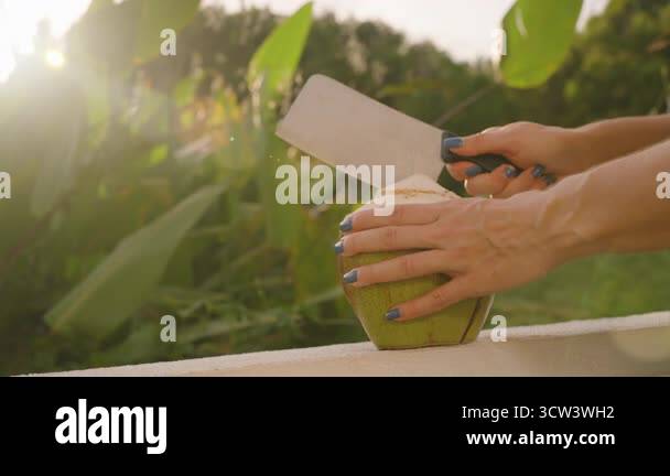 Coconut Juice Splashing in Slow Motion as Knife Hits Fruit on White ...