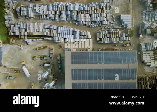 Aerial top view of a cement and concrete factory with rows of pipes ...