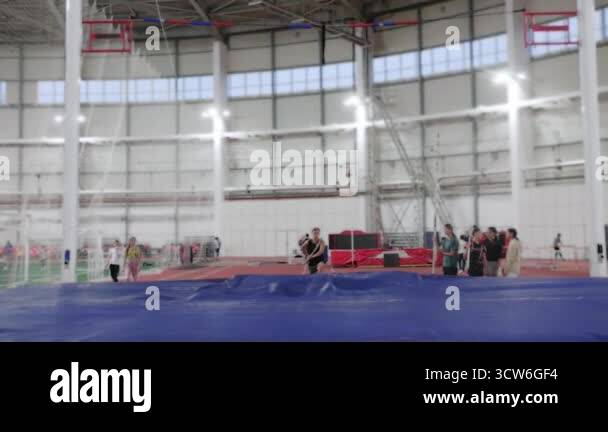Young man successfully pole vaulting over the bar and landing on the ...