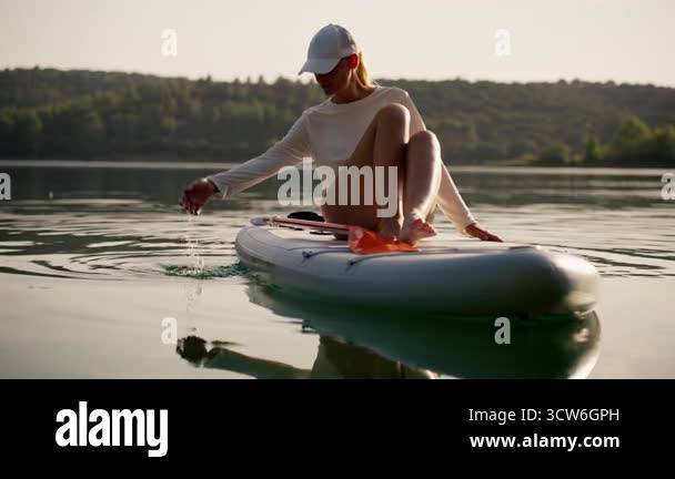 young woman in a swimsuit on an inflatable boat in the water. the girl ...