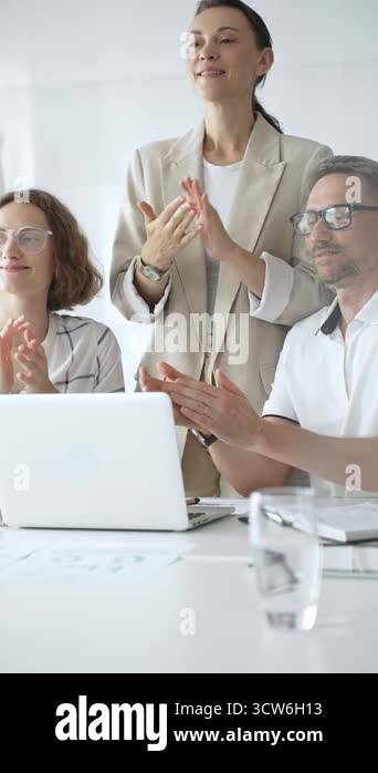 Business people clapping hands during a meeting in the office ...