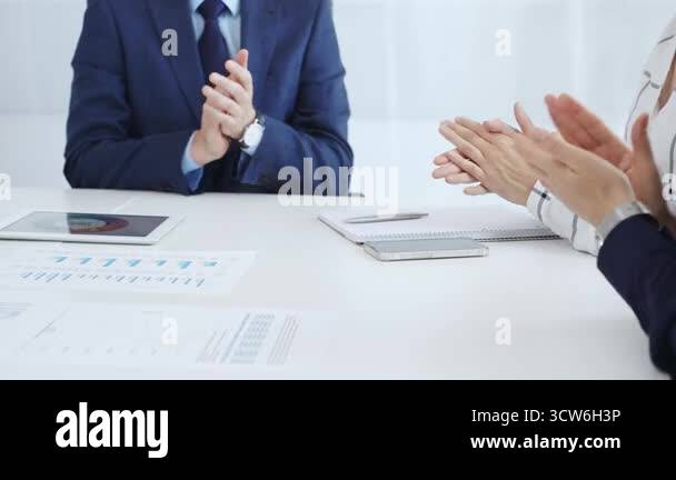 Professional colleagues clapping hands, celebrating successful ...