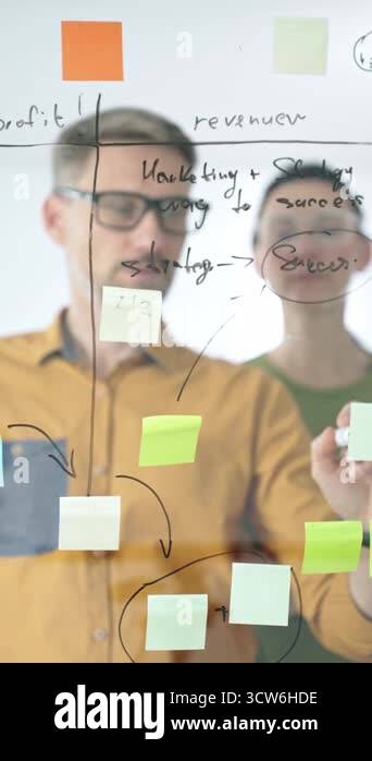 Business Team Collaborating On Success Strategies Using Colorful Sticky Notes And A Black