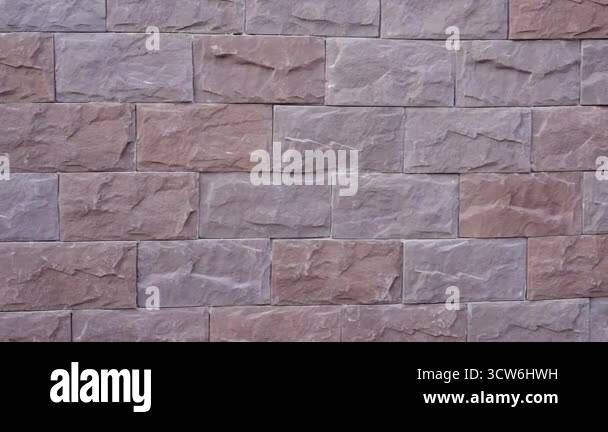 Finished section of a facade with decorative stone tiles installed on ...
