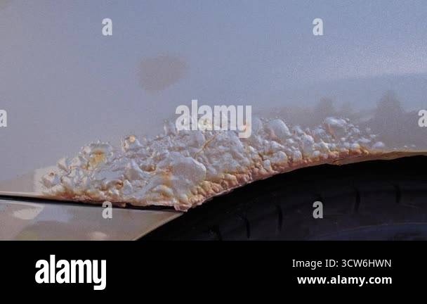 Close-up video of severe rust damage and blistered paint on a car ...