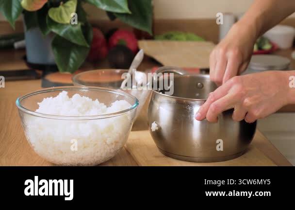 Scooping rice from glass bowl with spoon. Unrecognizable person ...
