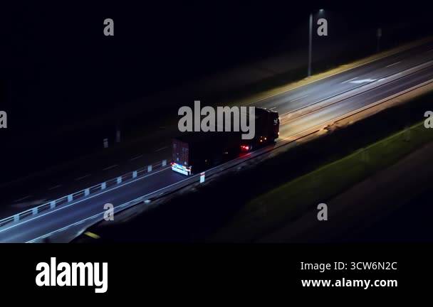 Truck driving on road at night, nonstop cargo delivery. Freight vehicle ...
