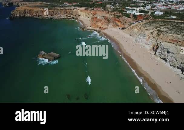 Drone flying slowly over famous and beautiful Praia do Tonel beach ...