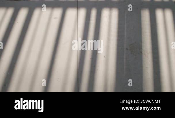 Shadow of metal railing on tiled floor. Abstract background of shadows ...