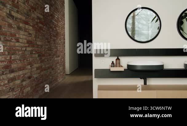 Stylish modern bathroom features a minimalist vanity set against a ...