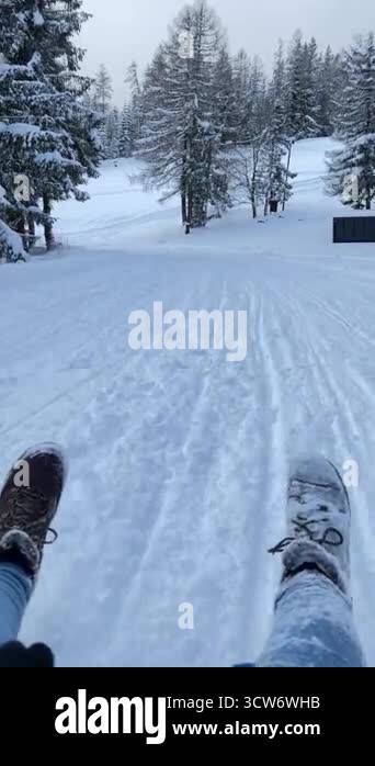 Vertical first-person video of sledding down a snowy hill on Hrebienok ...