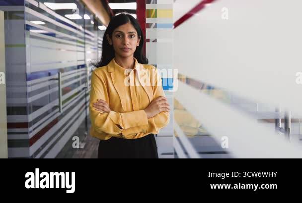 Young Indian business woman dressed in elegant yellow blouse stands ...