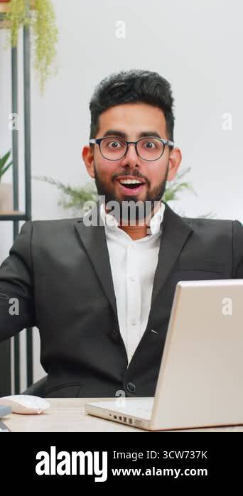 Excited amazed Indian businessman freelancer looking shocked surprised ...
