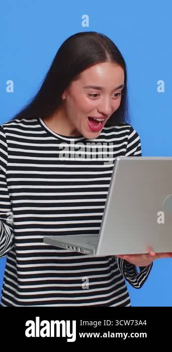 Happy excited Caucasian woman typing on laptop, working on project ...