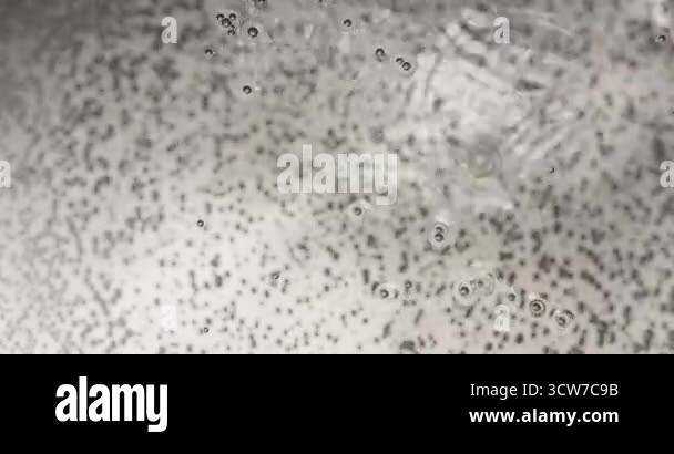 boiling water texture closeup on electric stove, food closeup top view ...