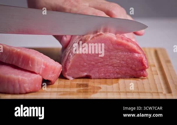 chef cut meat on cutting board with knife for making healthy meal and ...