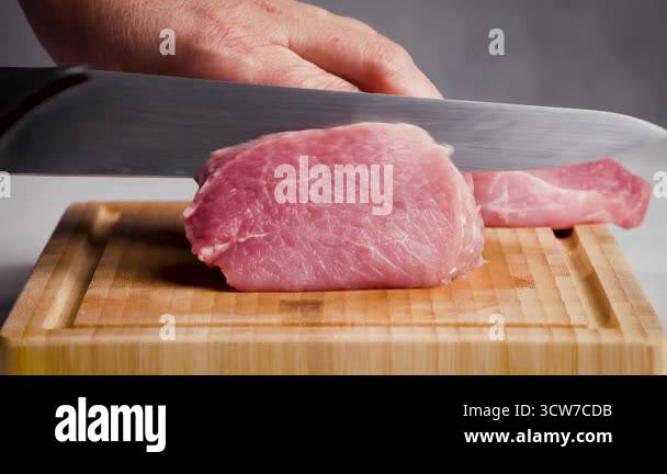 chef cut meat on cutting board with sharp knife for making healthy meal ...