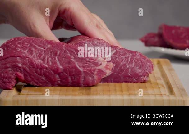 chef cut meat on cutting board with knife for making healthy meal and ...