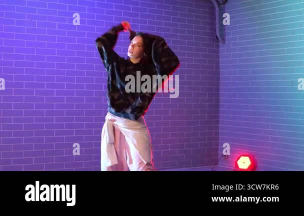 young girl choreographer dancing hip hop in neon lighting, woman ...