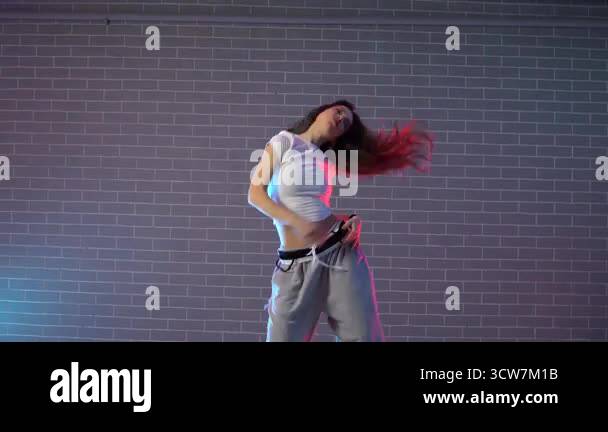 young girl choreographer dancing hip hop in neon lighting, woman ...