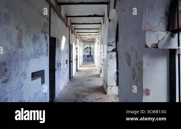 historic cellular jail symmetrical hallway in daylight video is taken ...