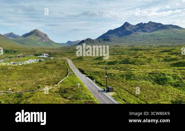 Witness the stunning aerial views of Isle of Skye showcasing vast green hills striking peaks and ...