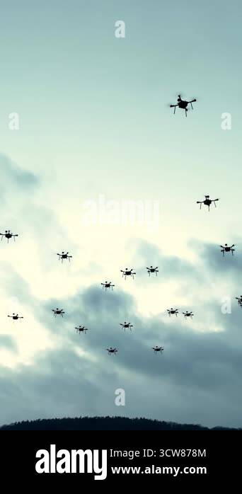 A large group of drones flying in formation against an overcast sky ...