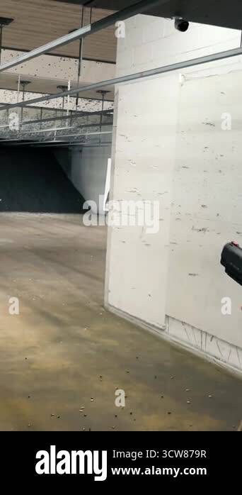 Person aiming at a target in an indoor shooting range, A person is seen ...