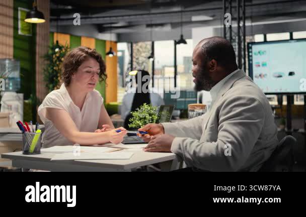 Black male applicant signing paperwork and receiving approval for ...