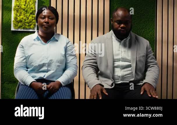 Candidates in the hallway receive forms from HR secretary with a ...