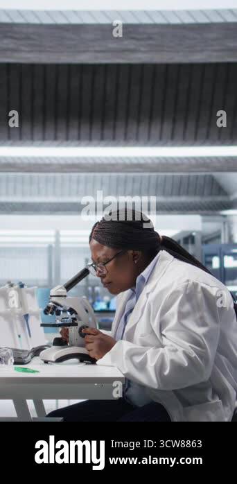 Vertical Video Researcher using microscope and specimen tray in ...