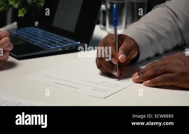 Close up of candidate singing employment contract terms and other ...
