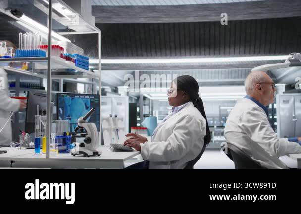 Diverse researchers in lab workspace conducting experiments and ...