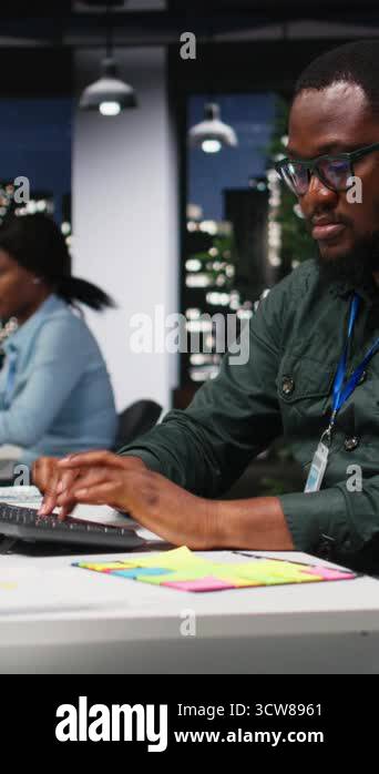 Vertical Video Black coworkers team monitoring forecast data for a new ...